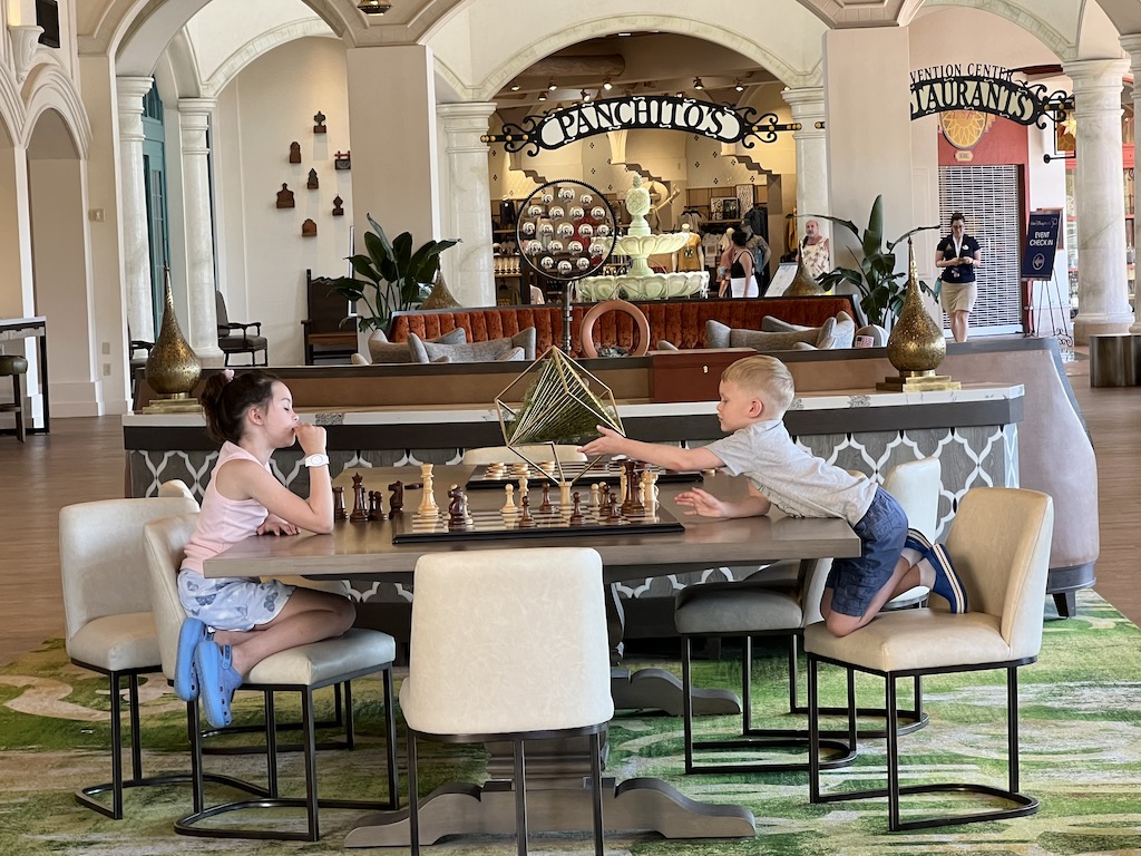 Kids playing chess near restaurants - The Unofficial Guides